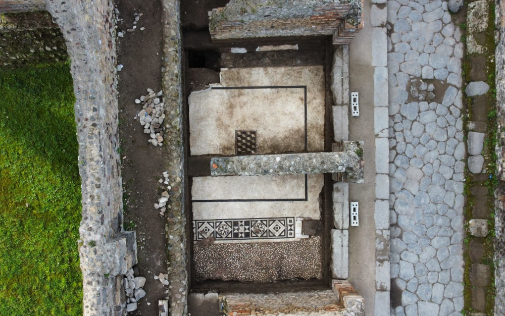 Mosaic floor of an older house emerges at Stabian baths